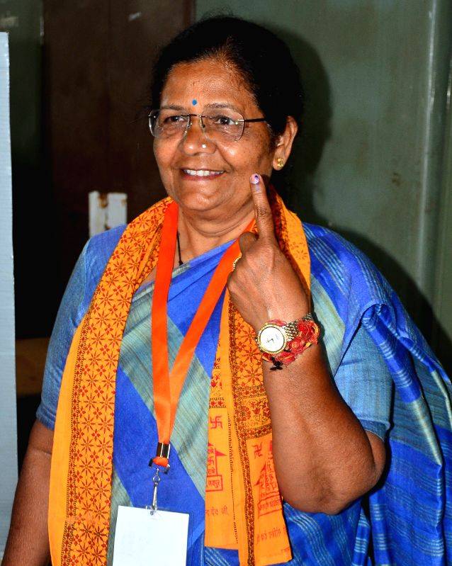 BJP candidate Manju Sharma shows her finger marked with indelible ink ...