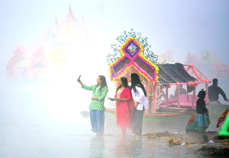 Devotees take selfies while celebrating Makar Sankranti at Gauri Ghat