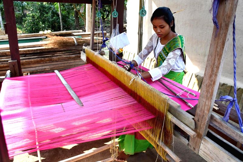 :Kokrajhar:A tribal women weaving â Dokhonaâ bodo traditional dress for ...