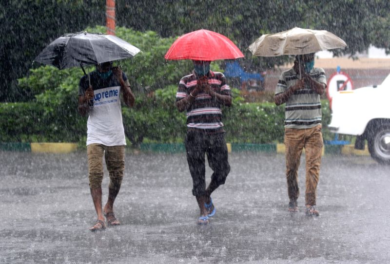 People use umbrella during rain in Kolkata.
