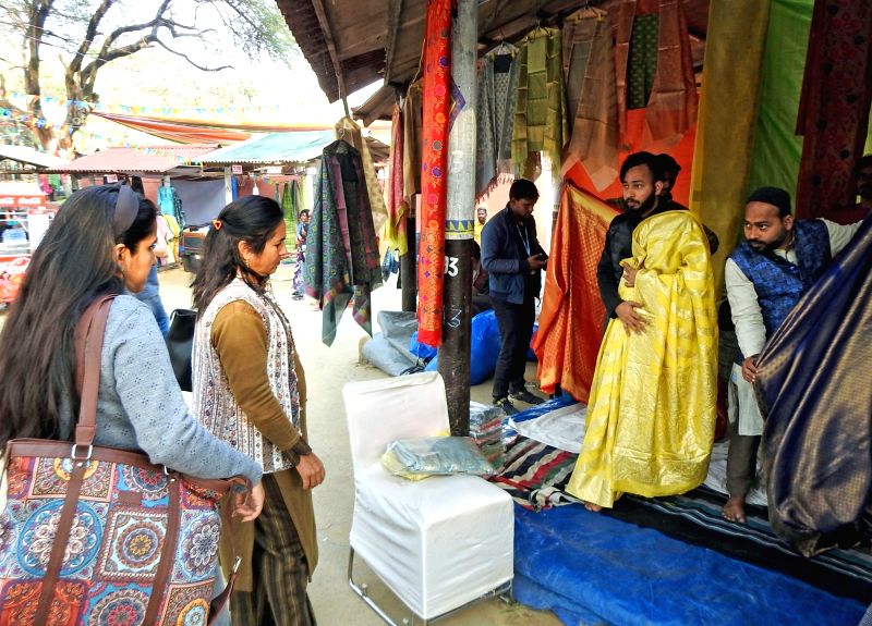Faridabad: Visitors look for items at a stall at the Surajkund Mela