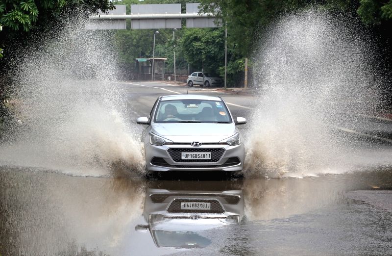 Water splash as car passing through the logged water at Bhairon marg ...